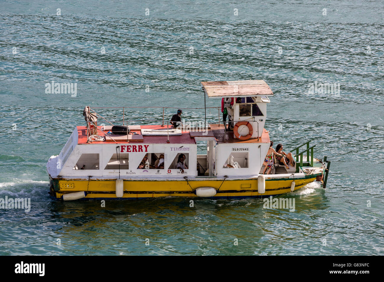 Tourists on St Lucia Ferry crossing bay Stock Photo - Alamy