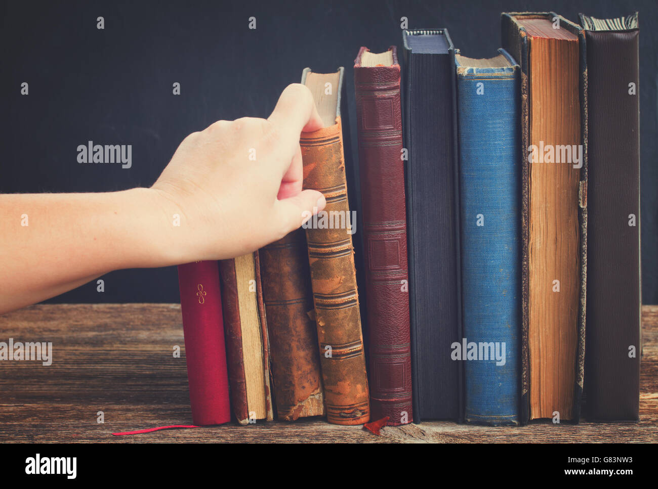 Bookshelf and hand Stock Photo - Alamy