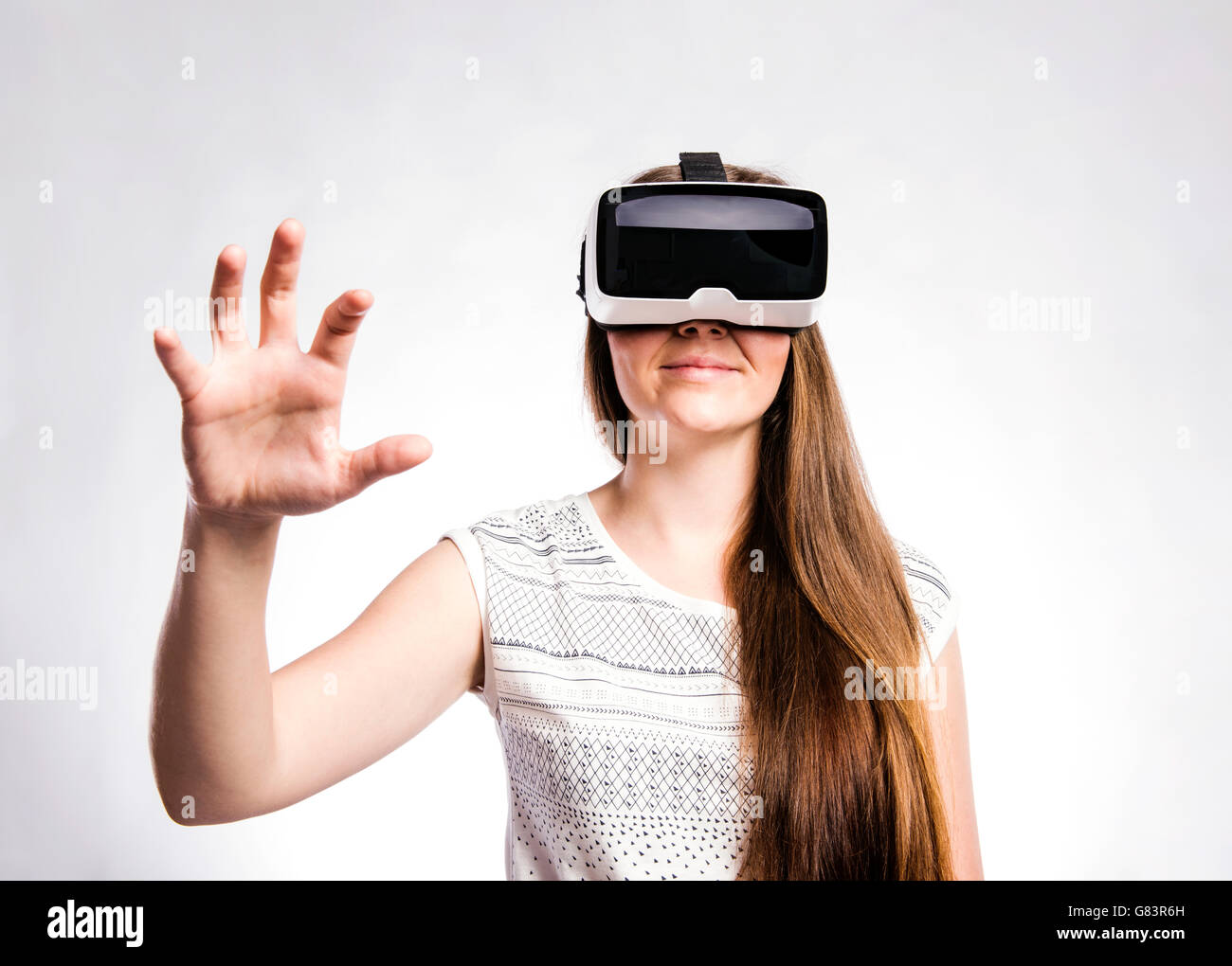 Woman with virtual reality goggles. Studio shot, gray background Stock ...