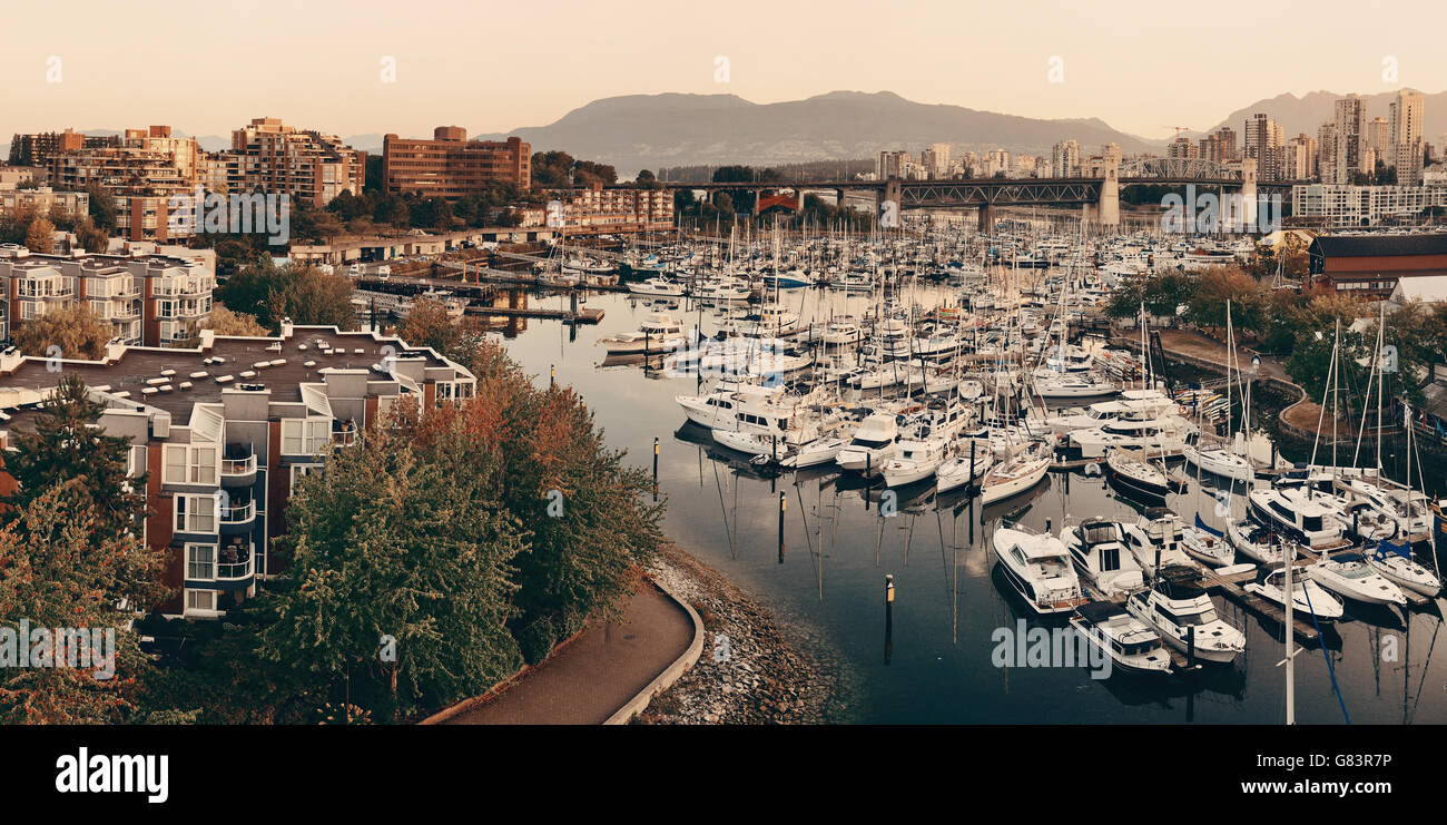 Vancouver harbor view with urban apartment buildings and bay boat in ...