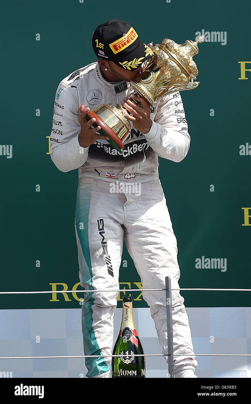 Mercedes driver Lewis Hamilton kisses the trophy after winning the 2015 ...