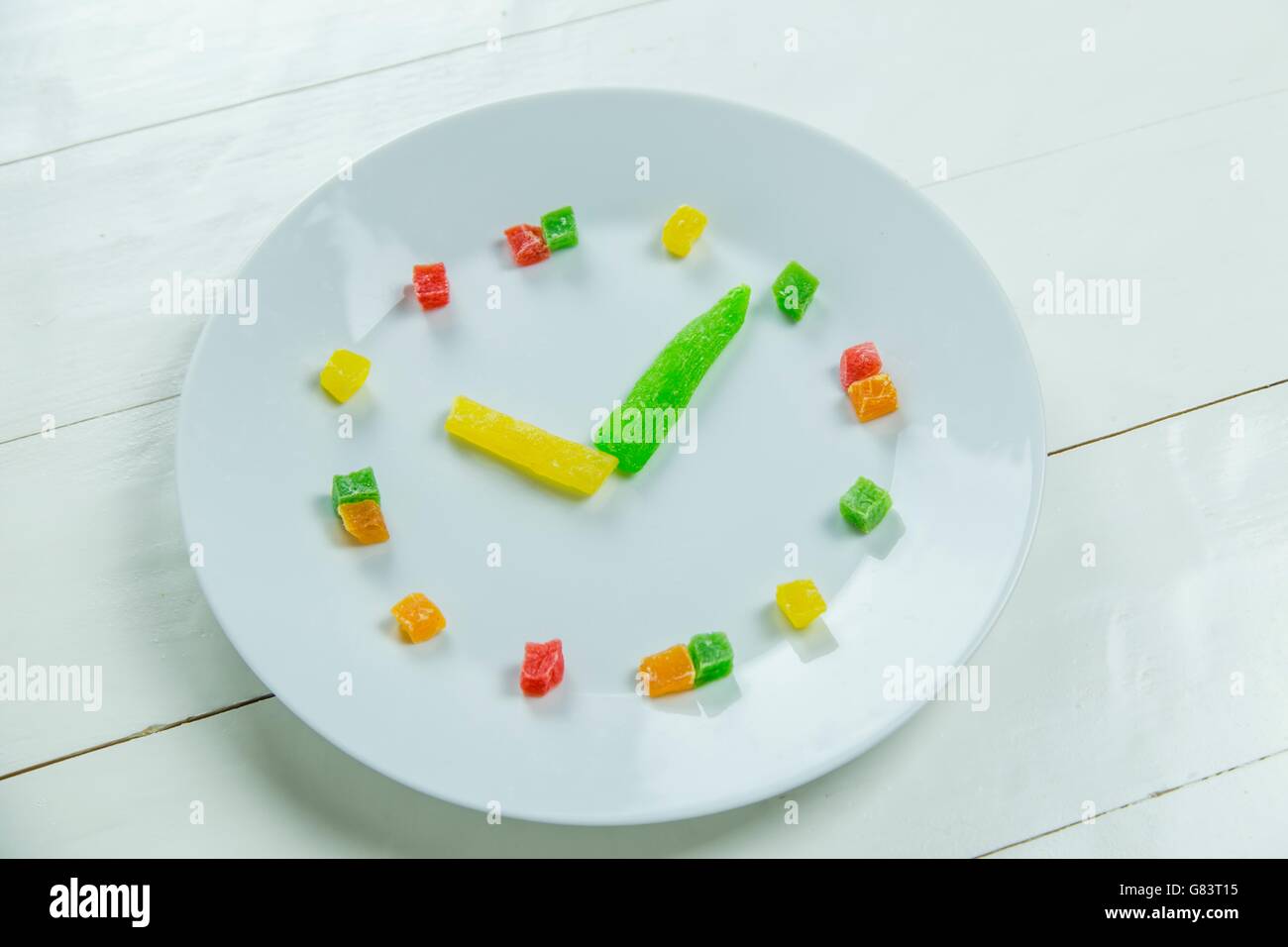 Fruit clock with candied fruits Stock Photo - Alamy