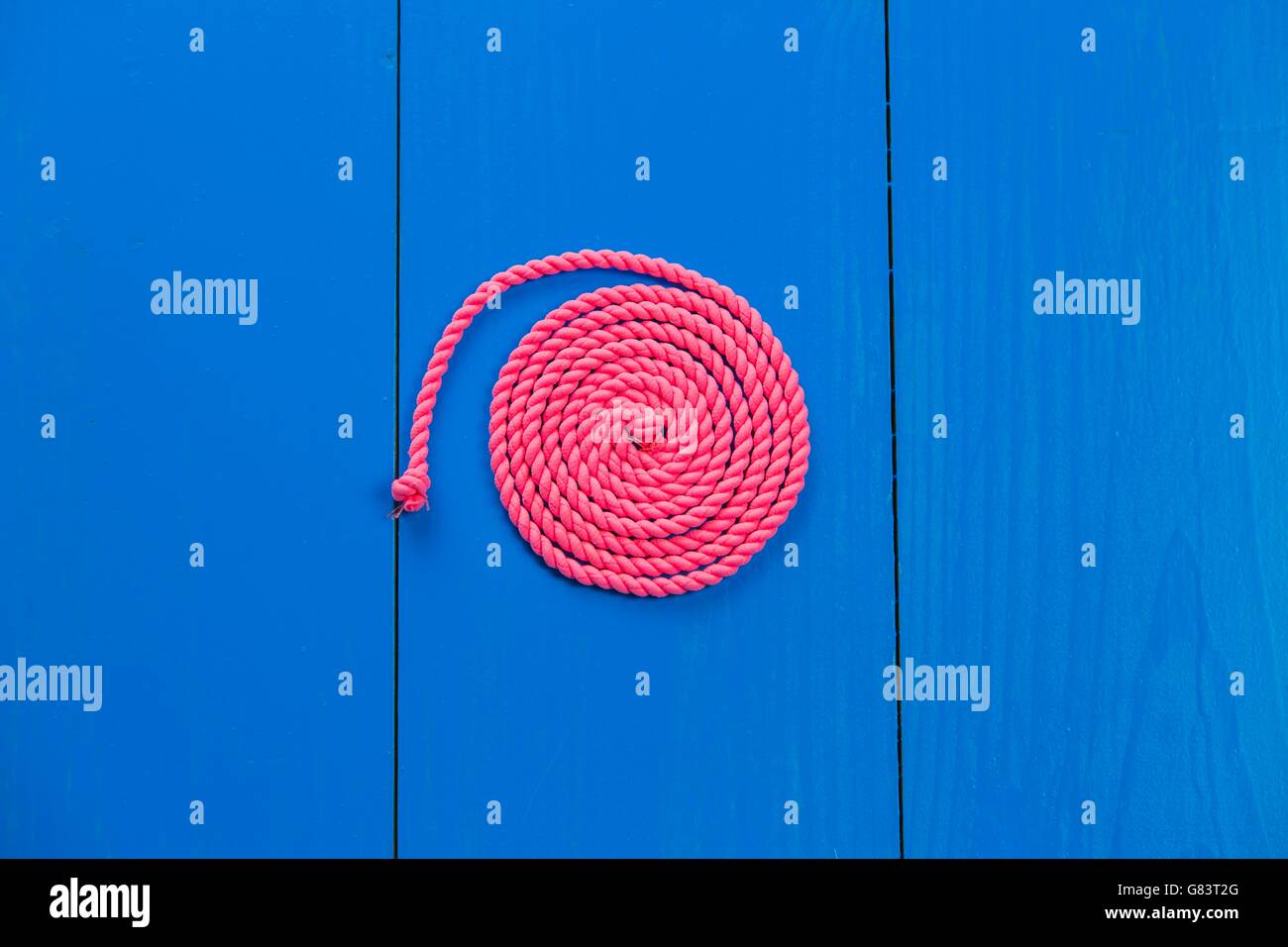 Pink rope circle on blue background Stock Photo - Alamy
