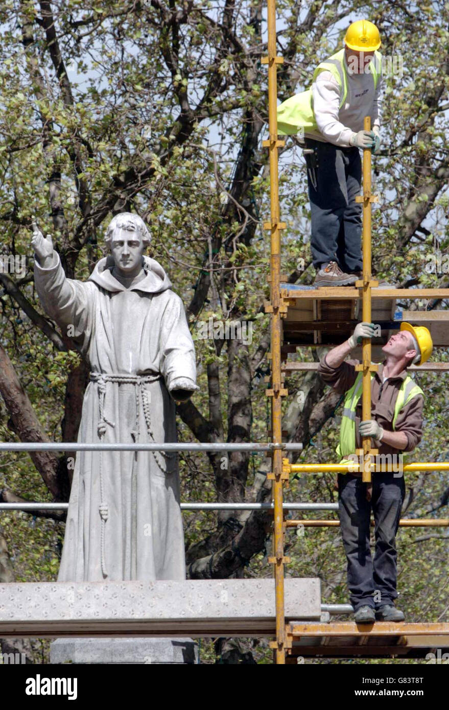 Workmen erect scaffolding around a statue of Father Mathew, so it can ...