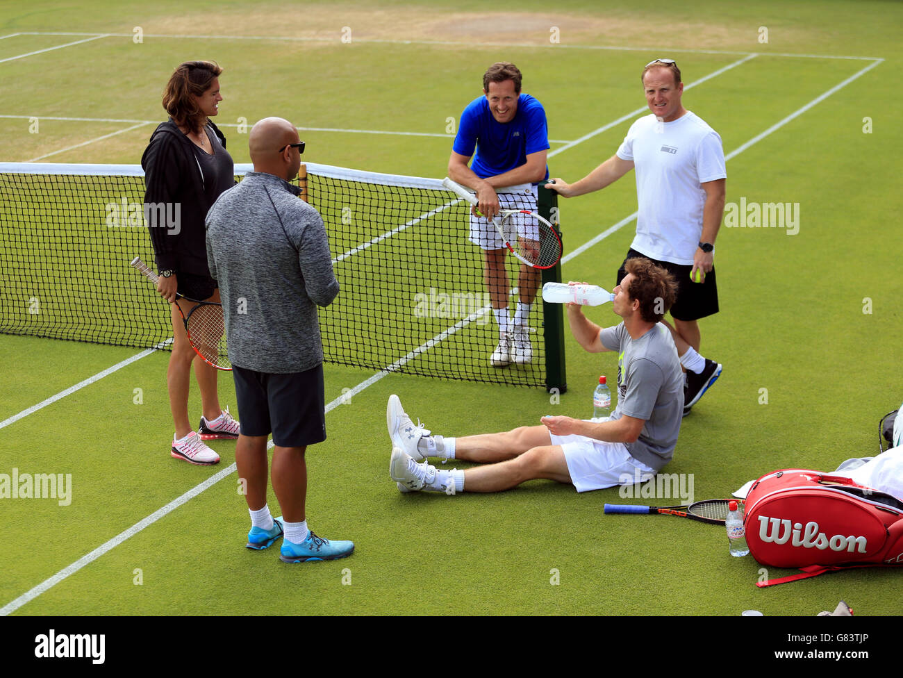 Andy Murray (on floor) takes a drink as his coaching staff including ...