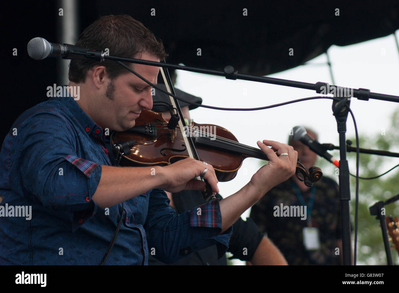 Andre Brunet, Quebecois musician playing fiddle/foot tapping for De Temps Antan performing at ...