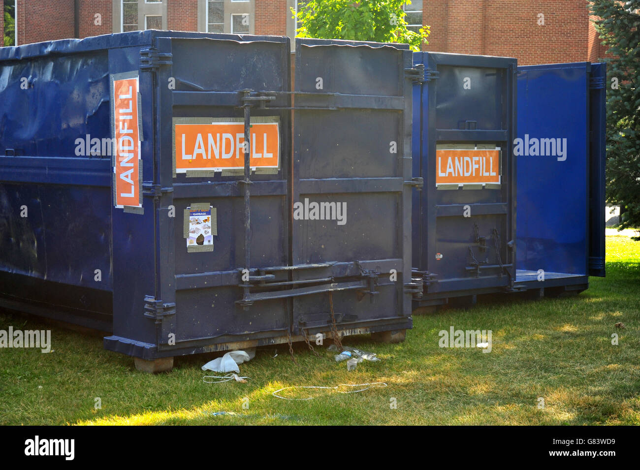Two large landfill containers placed at the side of a city festival in ...