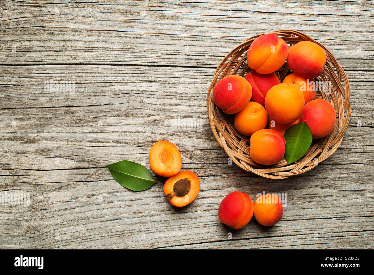 Fresh cut apricot fruits on wooden background Stock Photo - Alamy