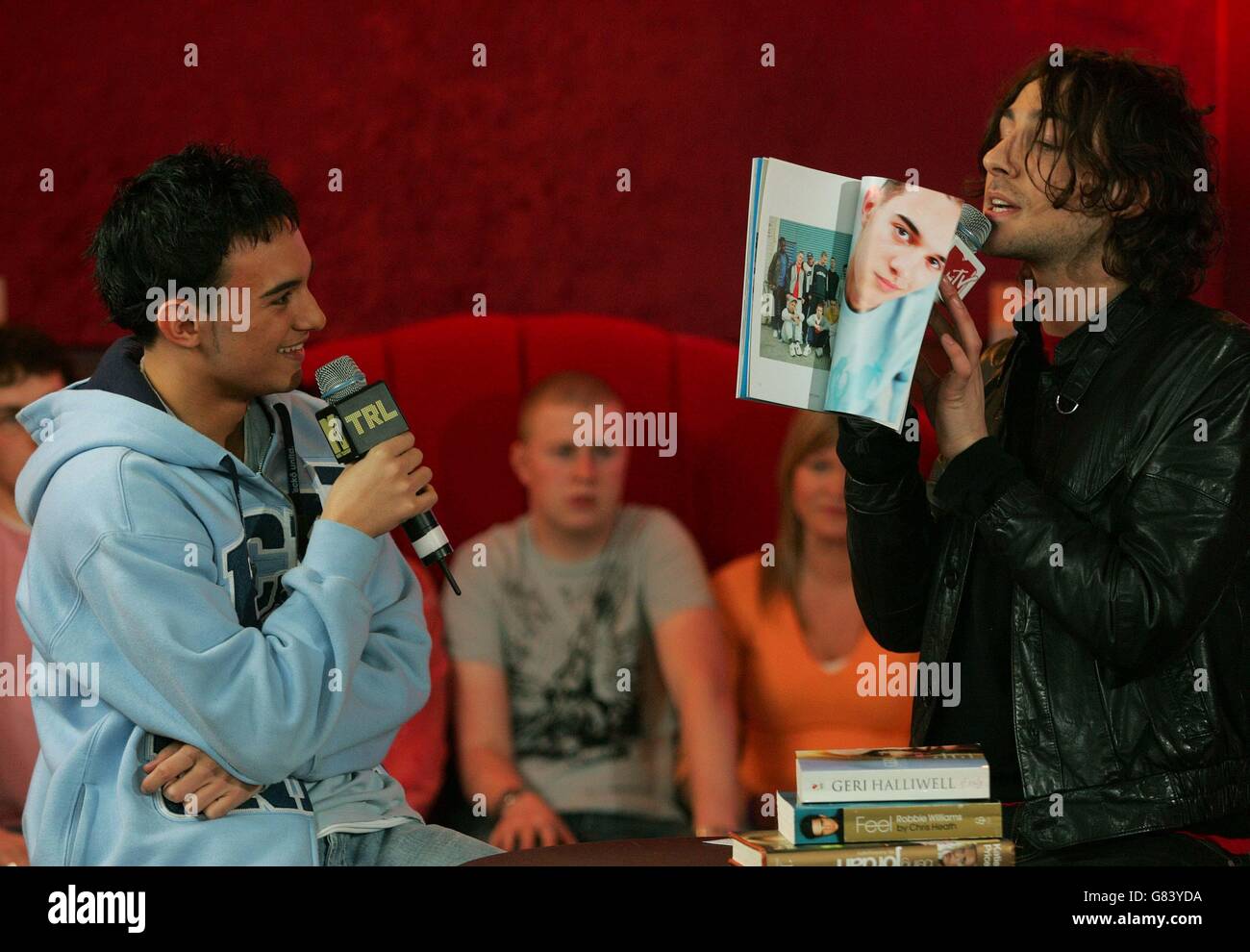 Pop star Kenzie, left, looks on as MTV presenter Alex Zane flicks ...