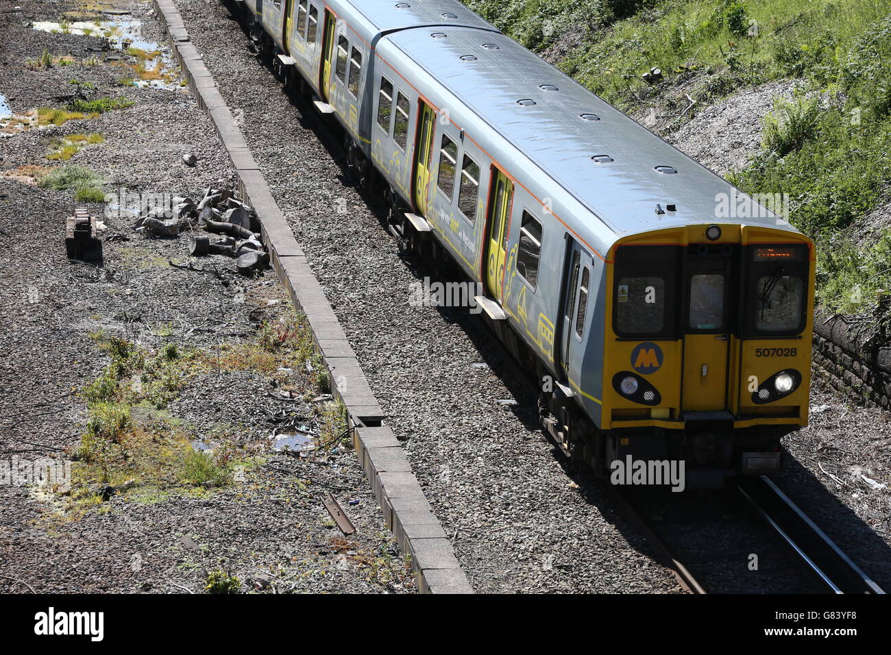 A Merseyrail train passes along track at Hunts Cross station Stock ...