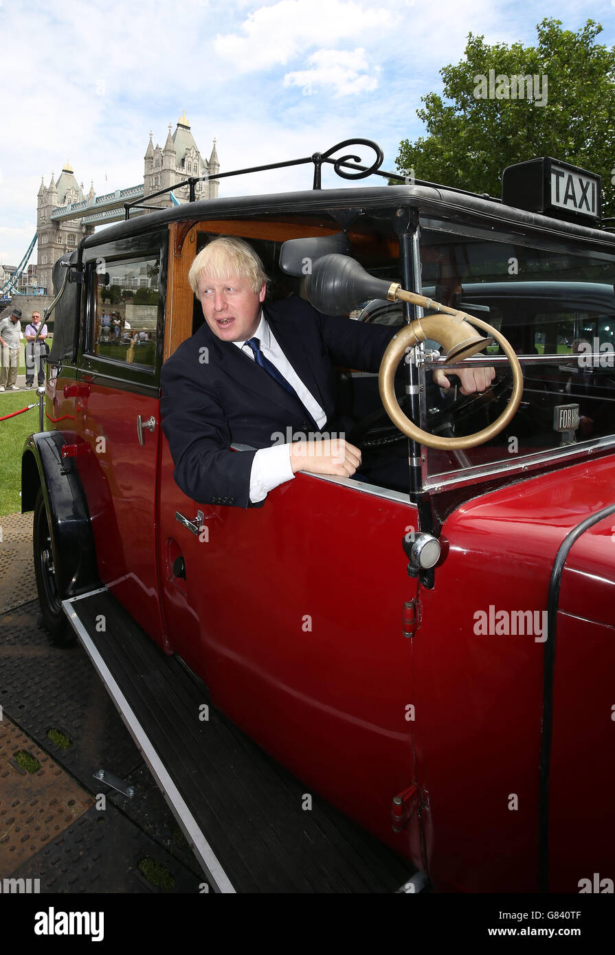 Mayor of London Boris Johnson sits behind the wheel of a 1936 London ...