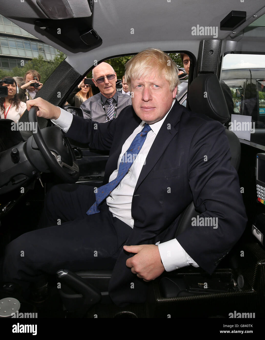 Mayor of London Boris Johnson sits behind the wheel of a new black cab ...