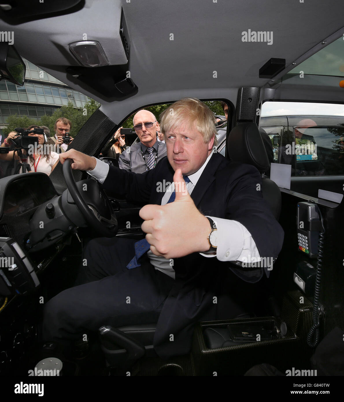 Mayor of London Boris Johnson sits behind the wheel of a new black cab ...