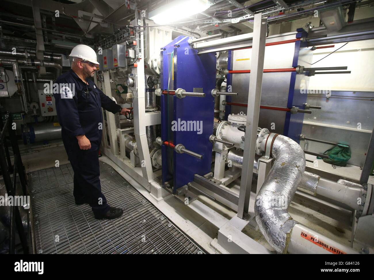 Petty Officer Bruce Milne views the cooling system in the forward ...