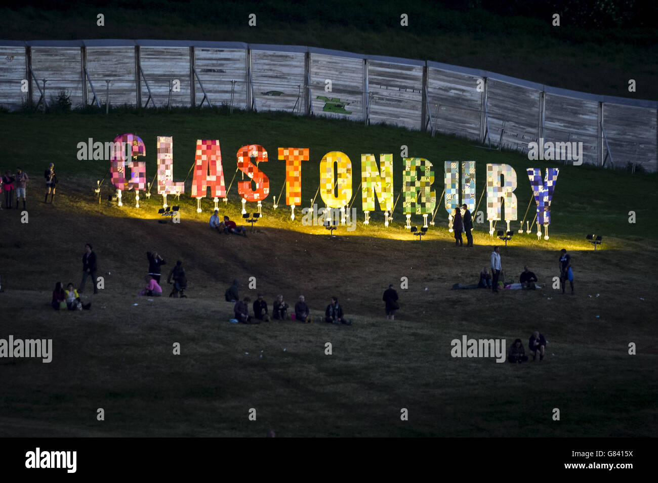 The Glastonbury sign and ring of steel fence after sundown at the ...