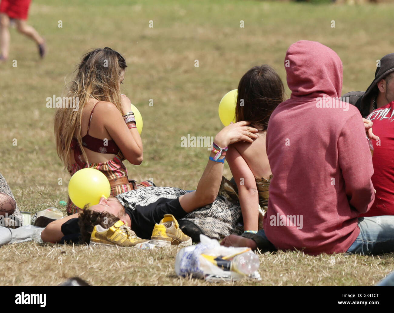 Festival goers inhaling balloons at the Glastonbury Festival, at Worthy ...