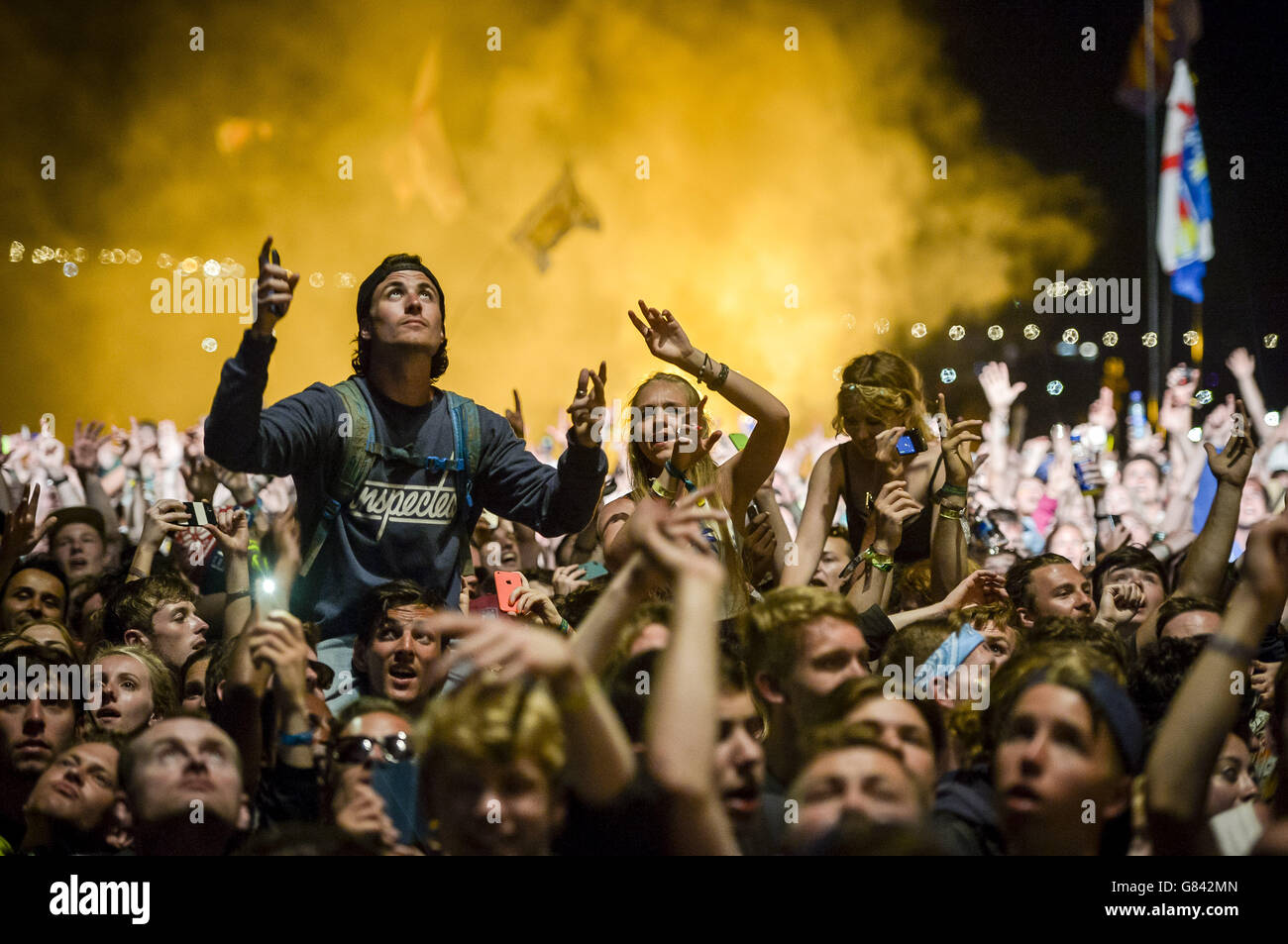 Fans dance on shoulders as they watch Kanye West performing on the ...