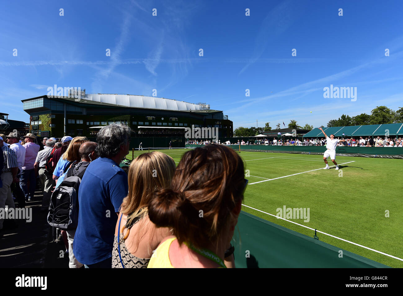Fans watch the action on court nine during day one of the Wimbledon ...