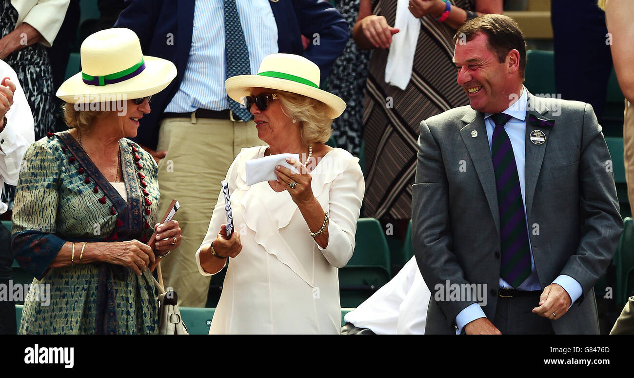 Chairman Philip Brook gives the Duchess of Cornwall (centre) Andy ...