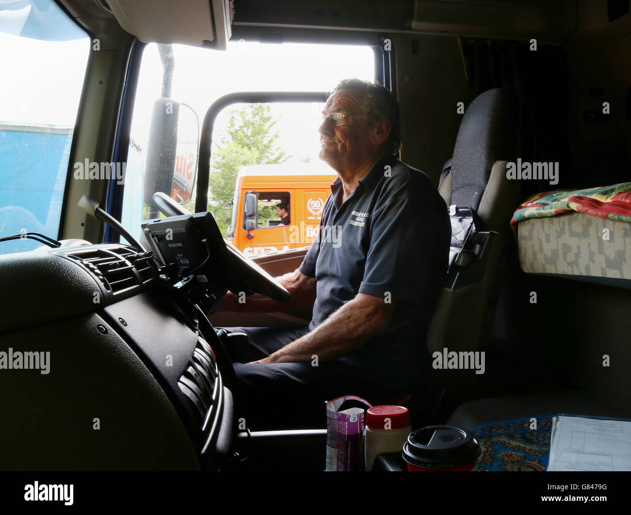 British lorry driver Graham Davis sits in his cab parked on the M20 in ...