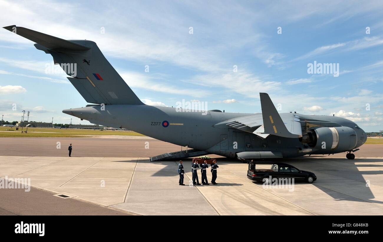 The coffin of Bruce Wilkinson is carried from the RAF C-17 at RAF Brize ...