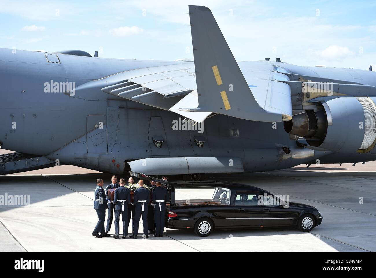The coffin of Bruce Wilkinson is placed in a hearse at RAF Brize Norton ...