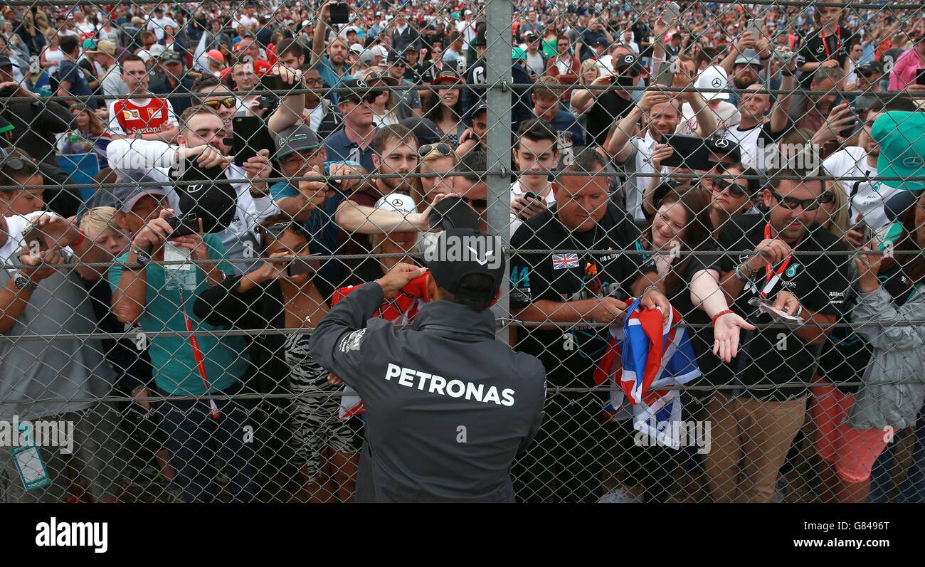 Mercedes driver Lewis Hamilton signs autographs with the fans before ...