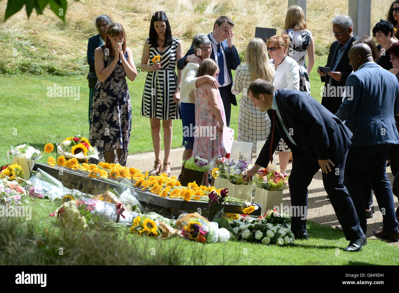 People leave flowers at the July 7 memorial in Hyde Park, London ...