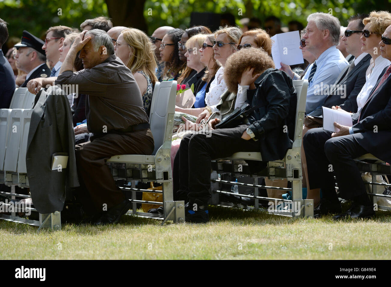 People attend a service at the July 7 memorial in Hyde Park, London, in ...