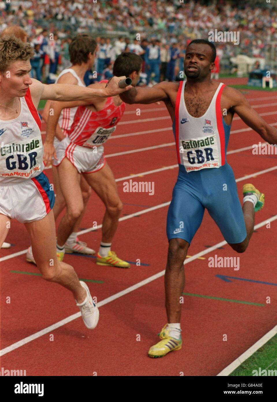 (L-R) -Brian Whittle, Kris Akabusi (both Great Britain) -handing over ...