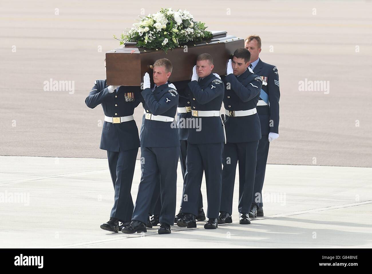 The coffin of Stephen Mellor is taken from the RAF C-17 carrying the ...