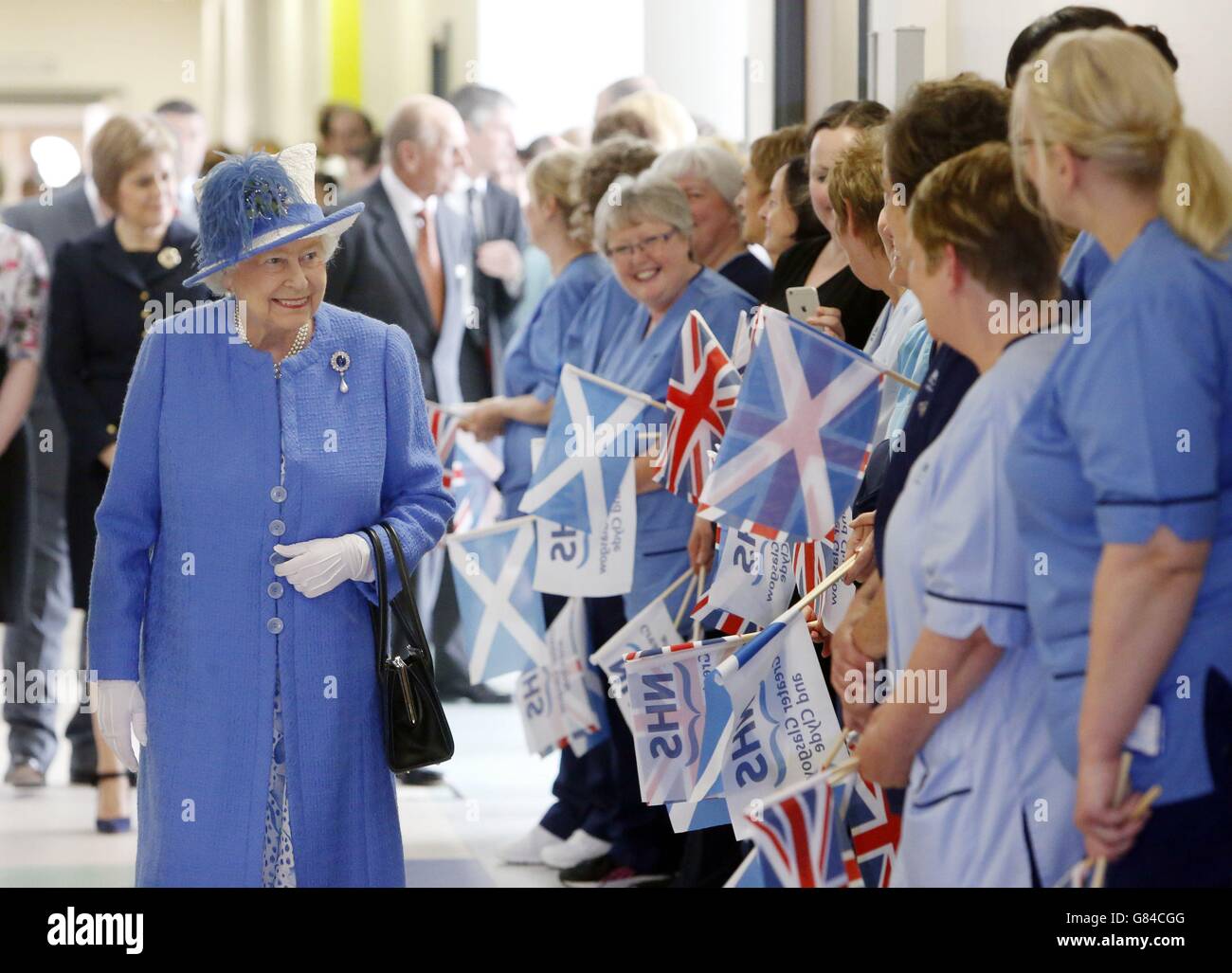 Queen Elizabeth II smiles as she meets staff during a visit to the ...