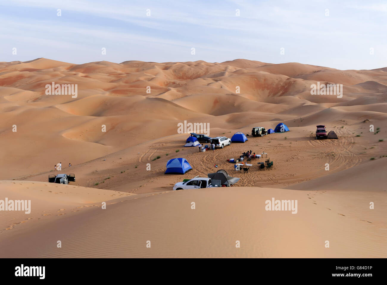 Friends camping in the Middle Eastern desert with off-road vehicles ...