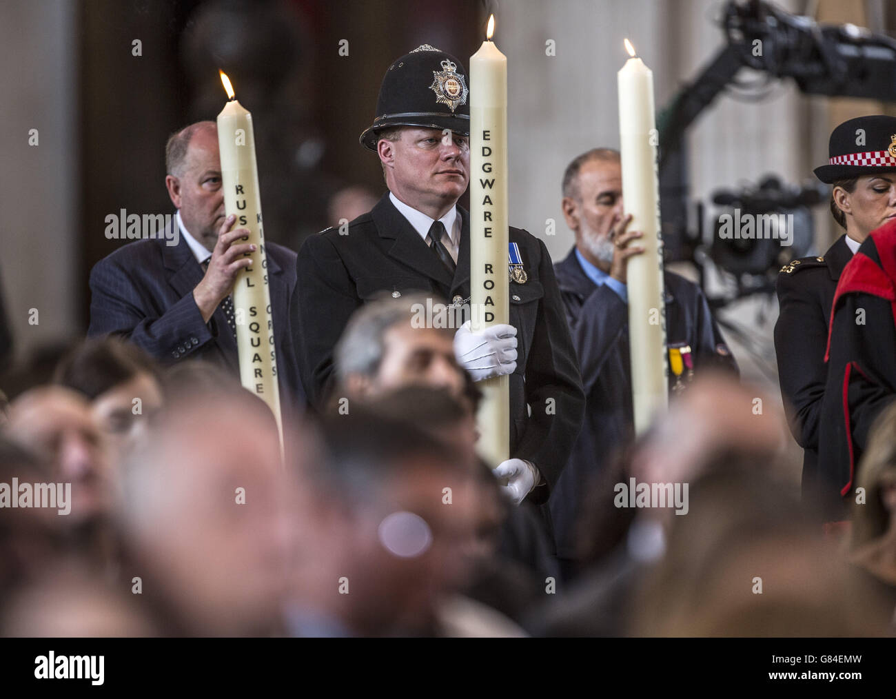 Candles bearing the names of the locations attacked are held during a ...