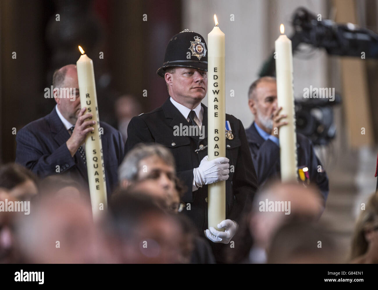 Candles bearing the names of the locations attacked are held during a ...