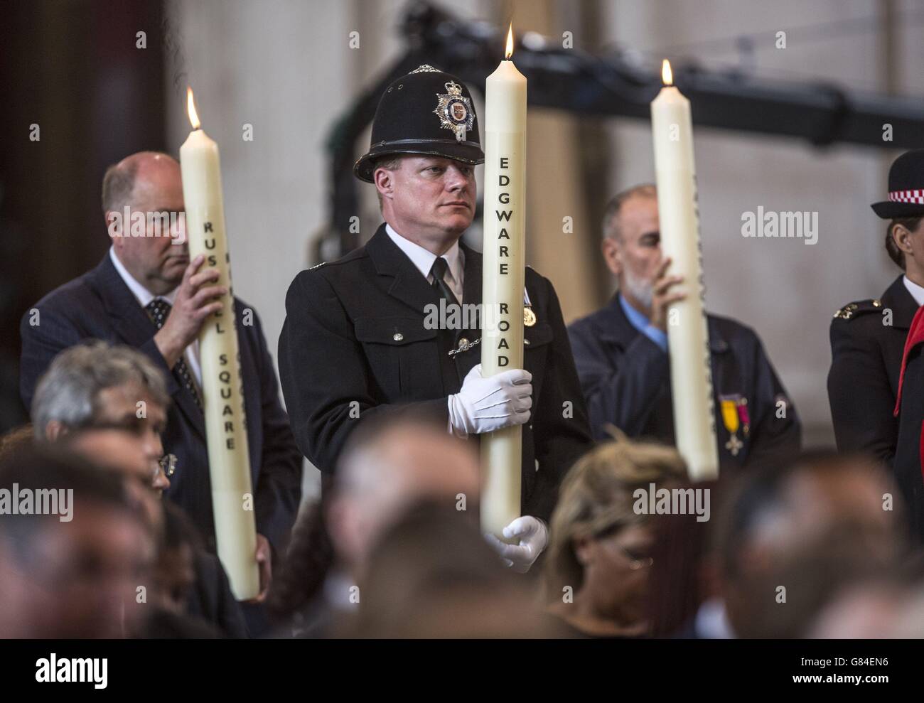 Candles bearing the names of the locations attacked are held during a ...