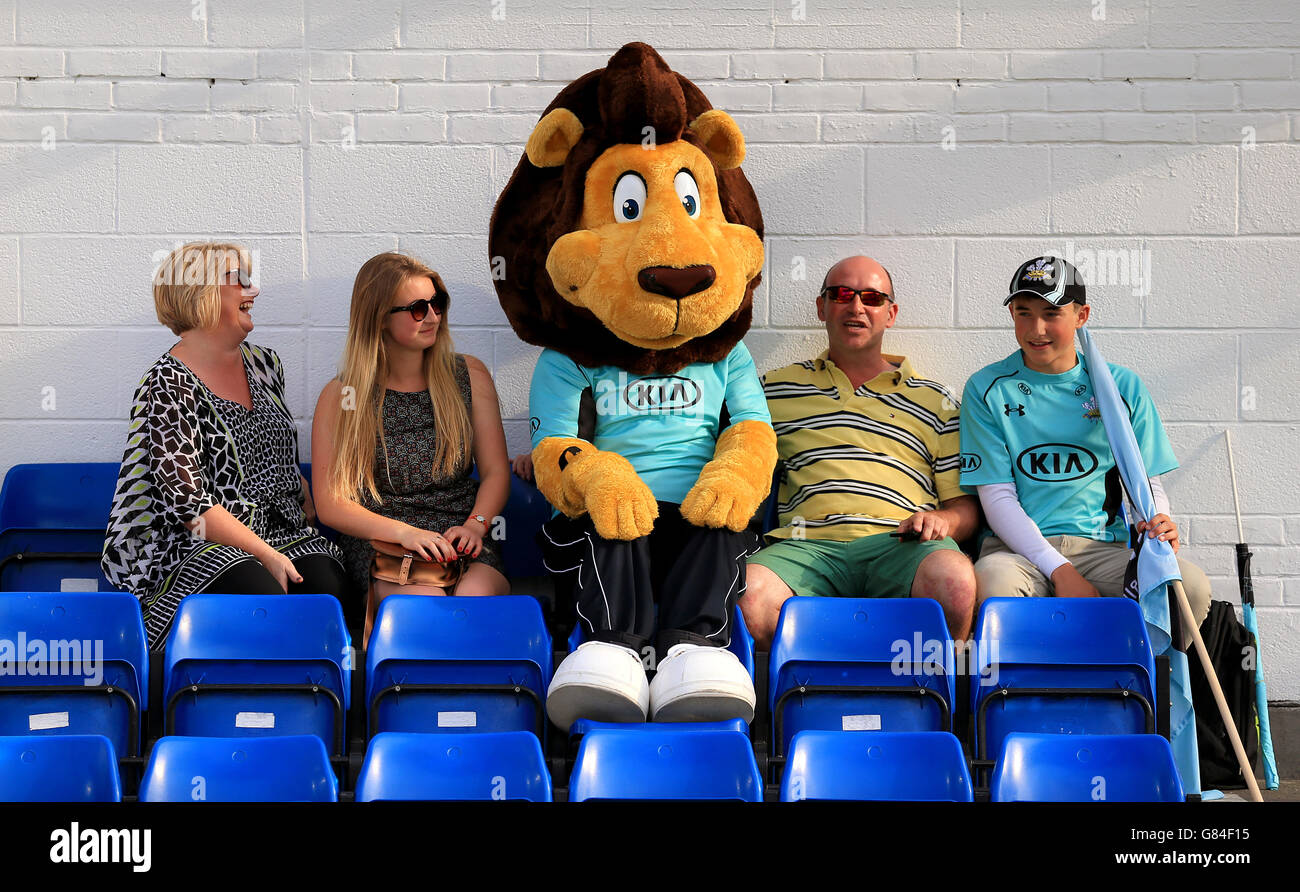 Surrey mascot Caesar the Lion sits with some fans before the game Stock ...