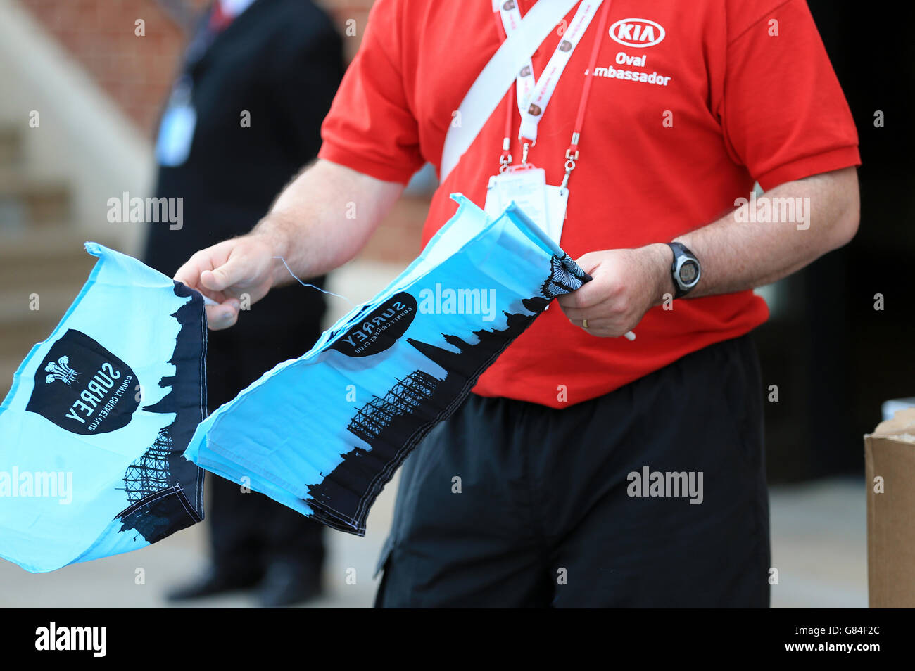 Surrey flags are handed out to fans to support the team before the game ...