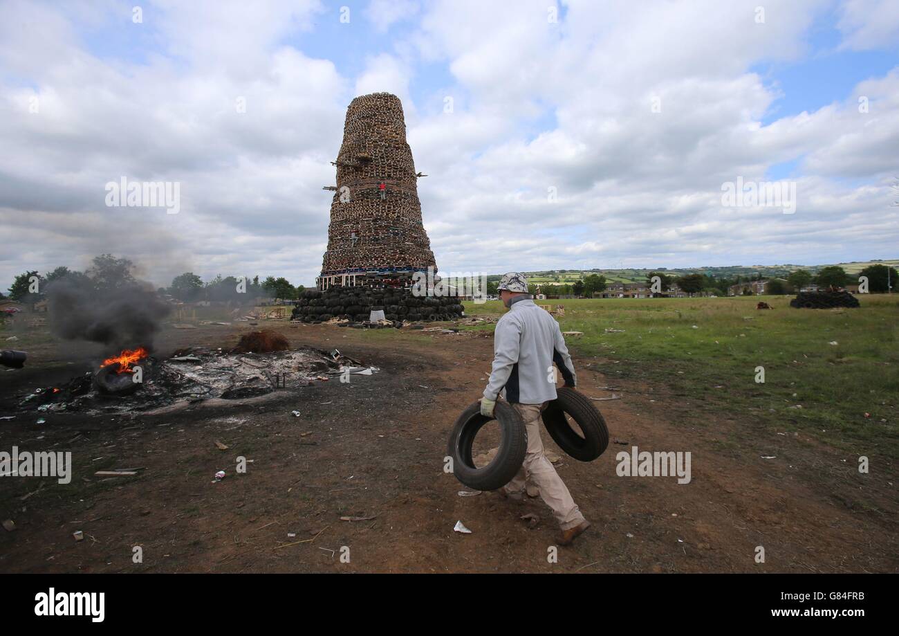 A bonfire builder in the New Mosley area of Belfast as hundreds of ...