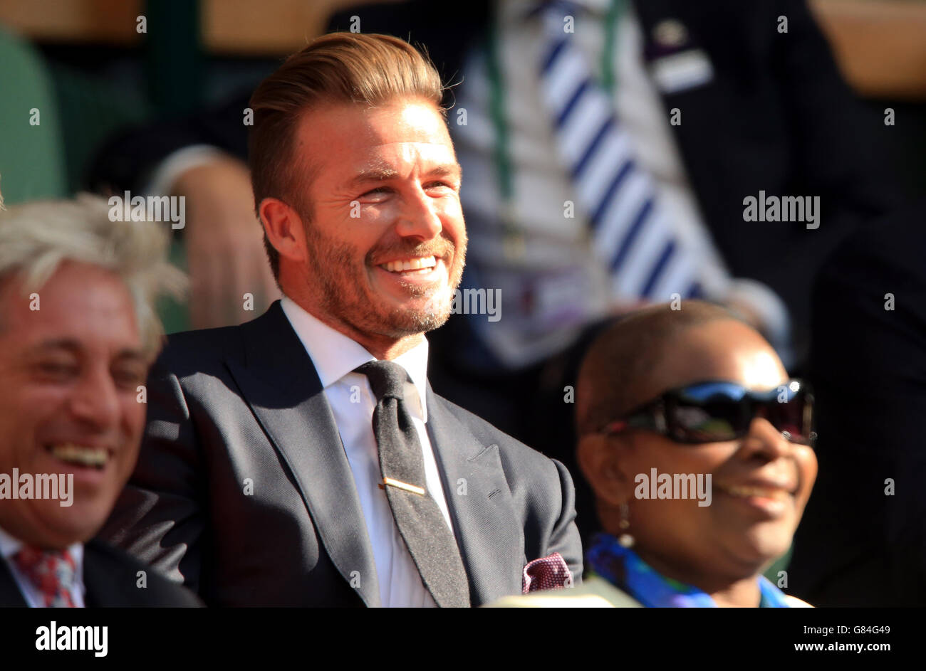David Beckham laughs after catching a tennis ball in the royal box ...