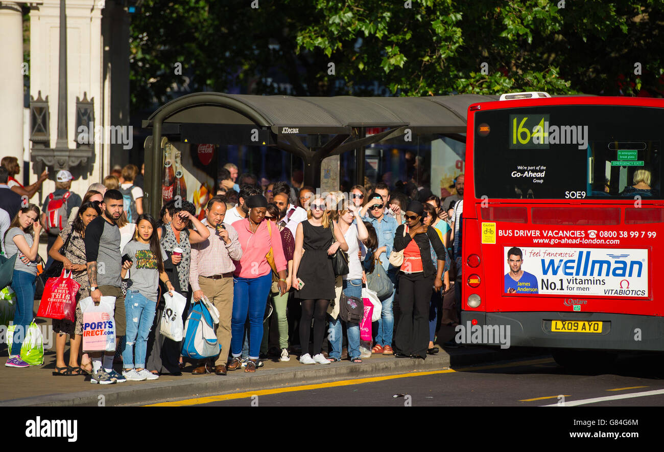 People queue for buses in Wimbledon, south London, during strike action ...
