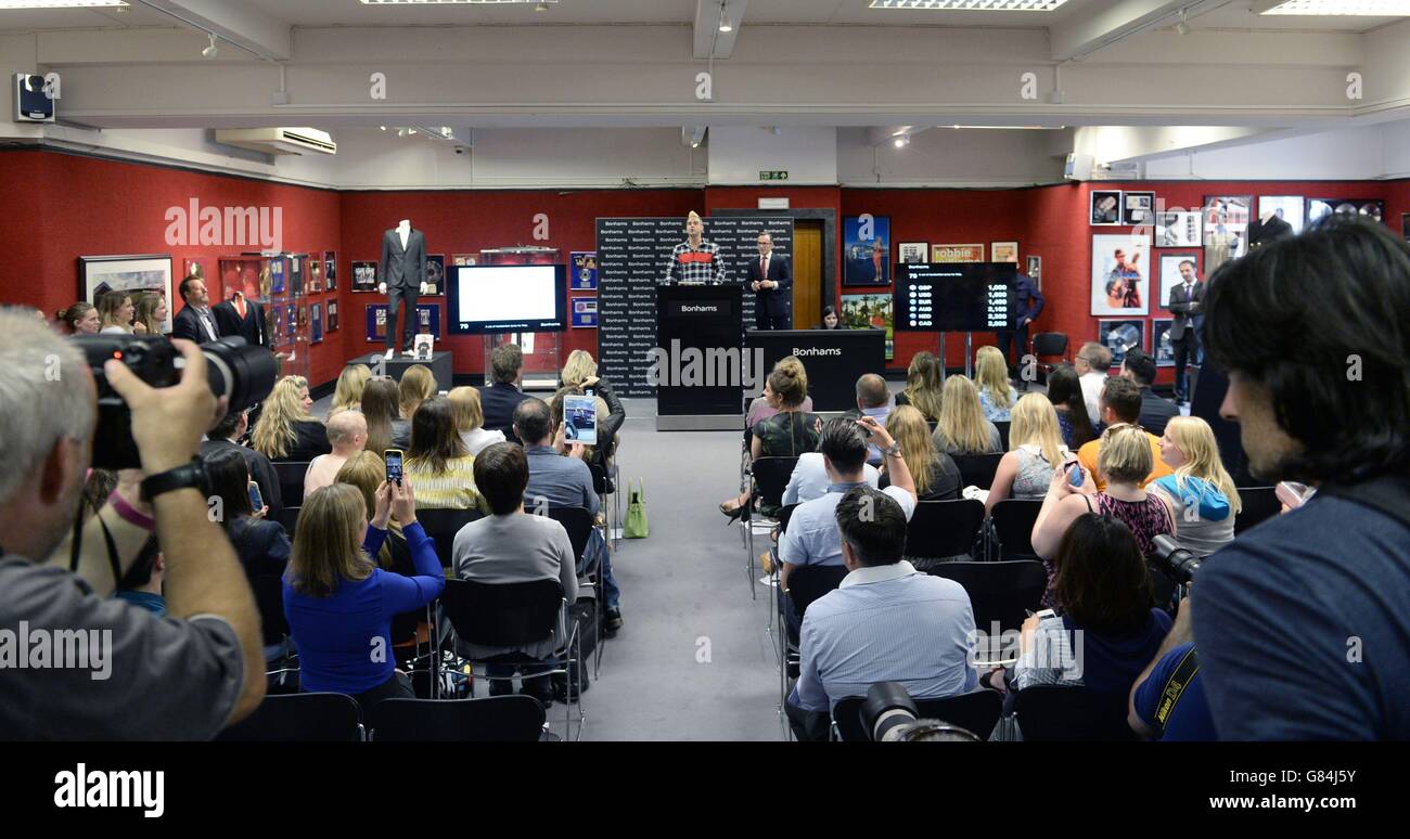 Robbie Williams auctions off items of his own memorabilia during a ...