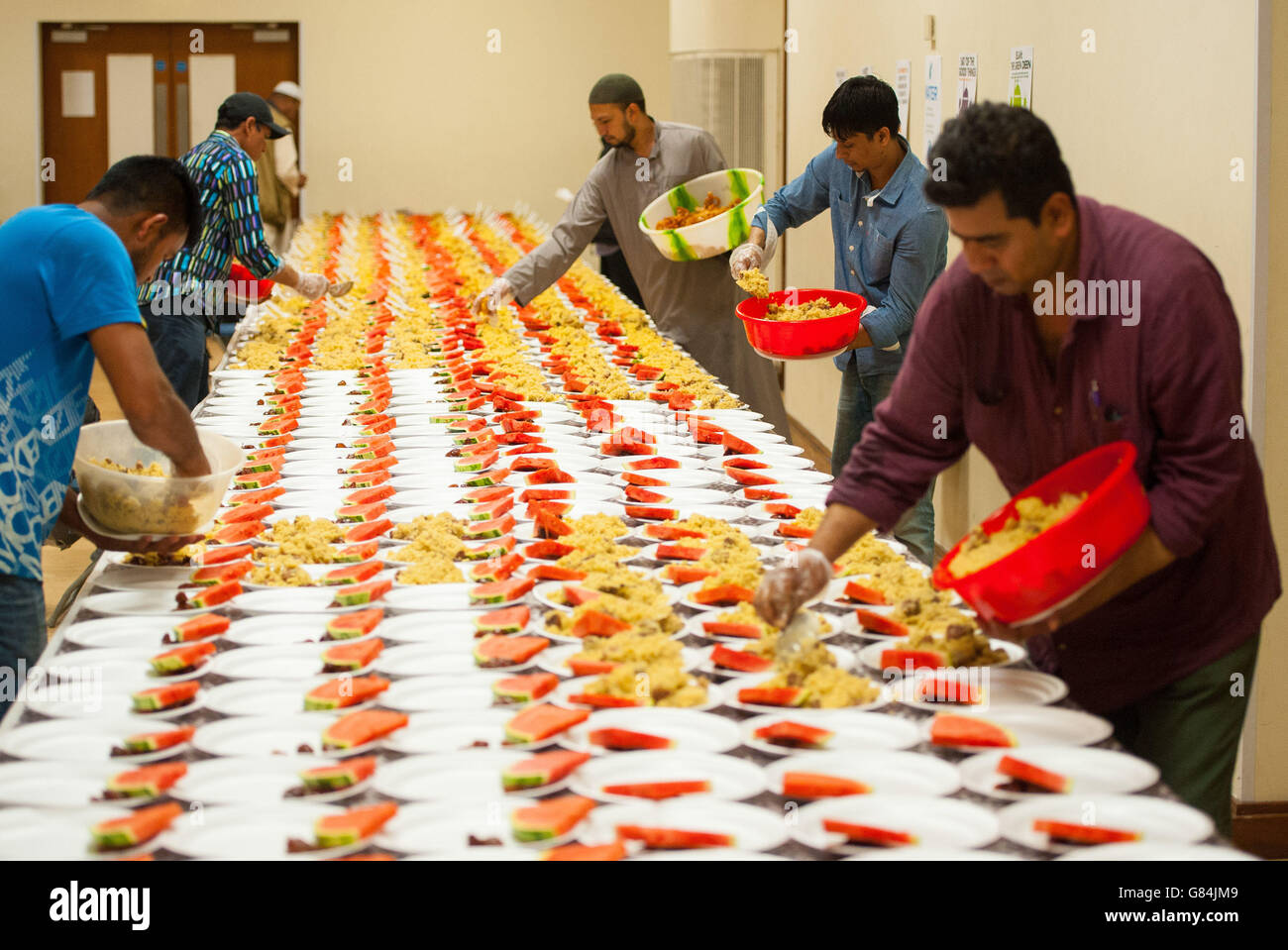 Staff prepare food for 500 people for the Iftar, the evening meal to ...