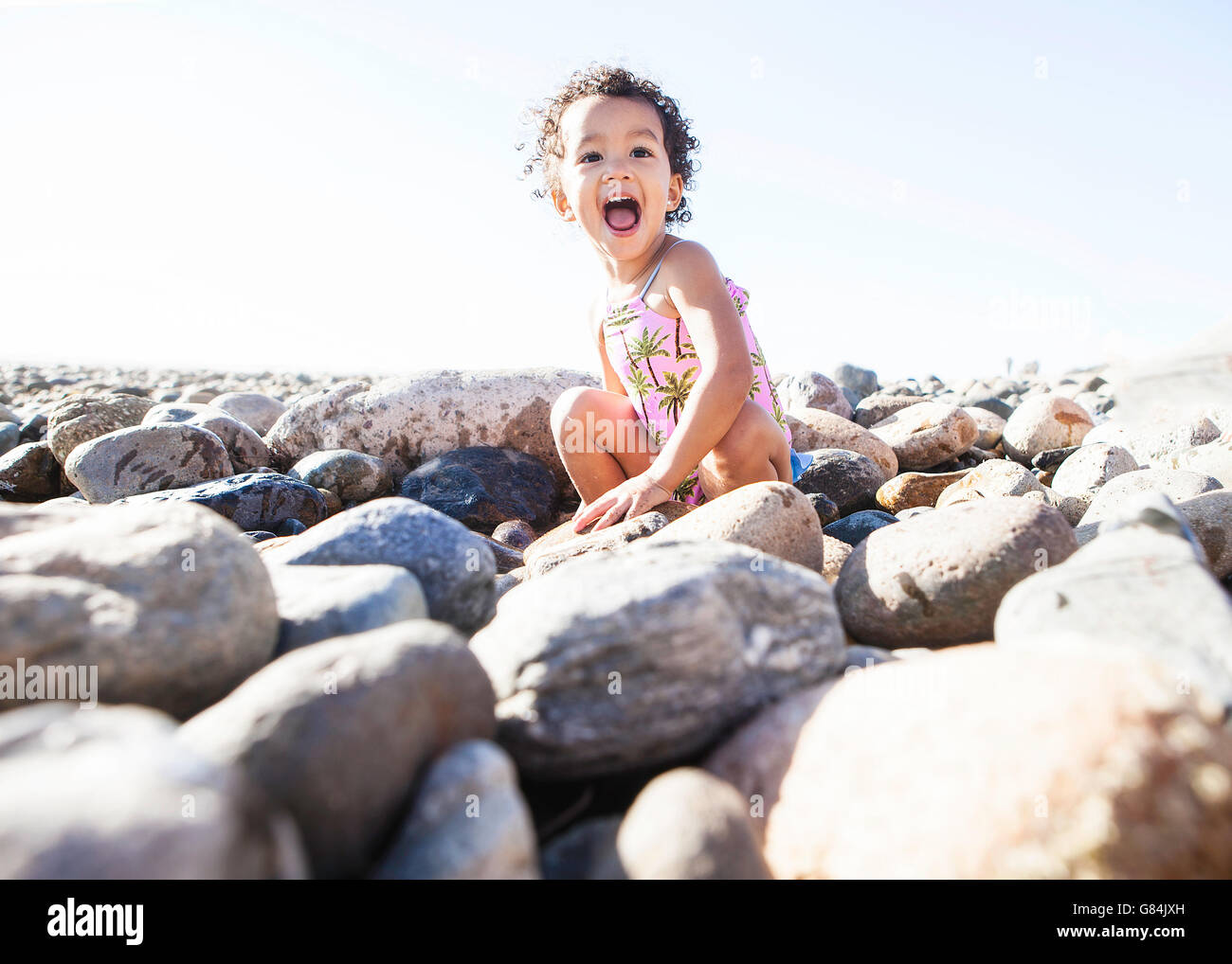 Girls sitting on rocks hi-res stock photography and images - Alamy