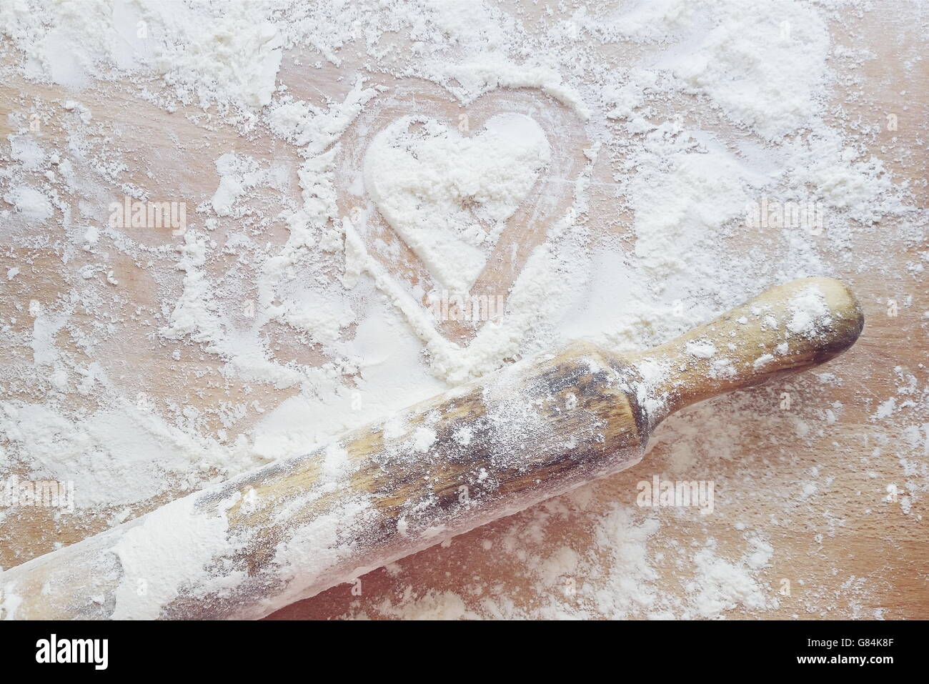 Heart drawn in flour with rolling pin Stock Photo - Alamy