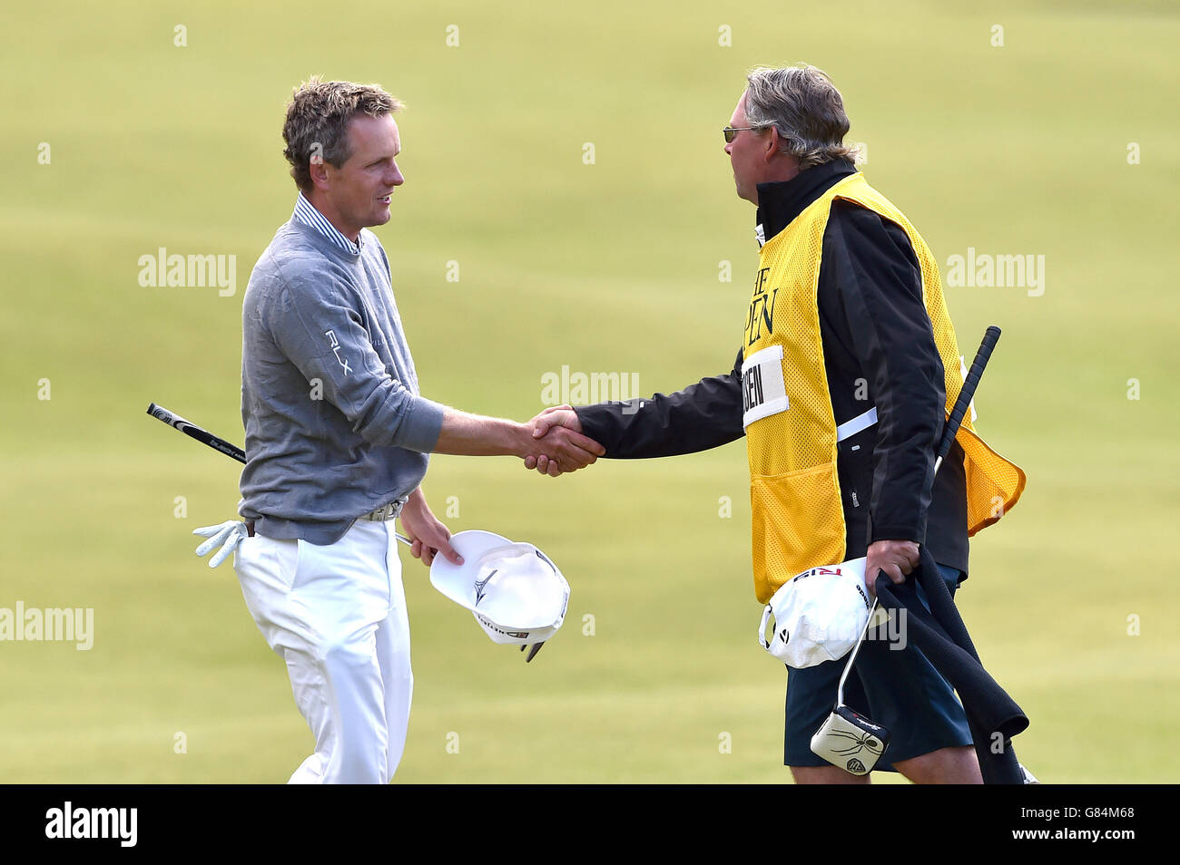 England's Luke Donald shakes hands with the caddie of South Africa's ...