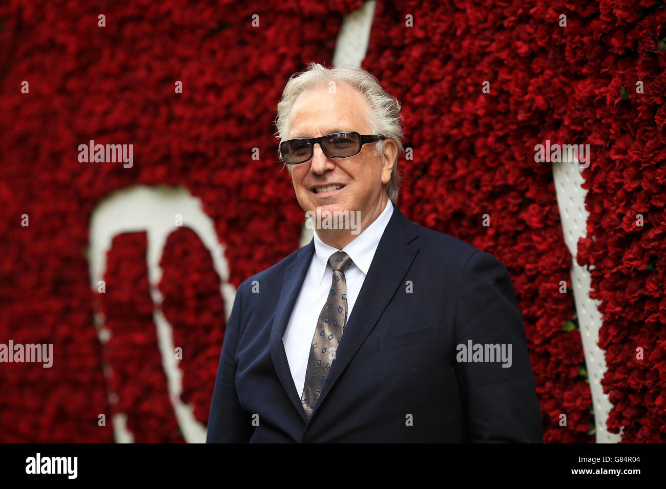 English actor Alan Rickman poses in front of the Qatar Tourism wall of ...