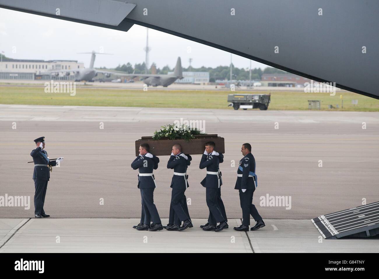 The coffin of Lisa Graham is taken from the RAF C-17 carrying the ...
