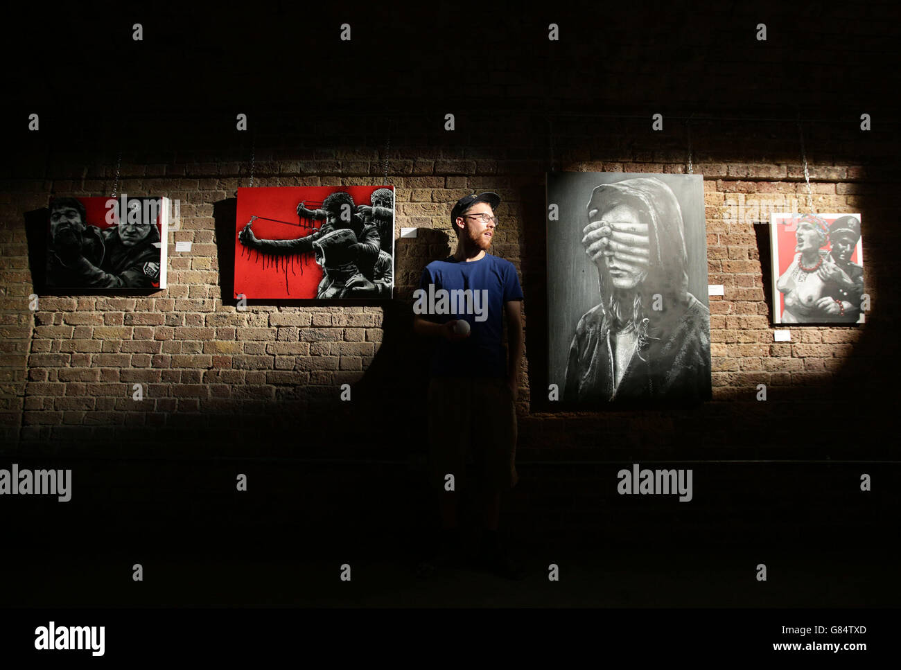 Artist Nils Westergard poses next to some of his work, during a press ...