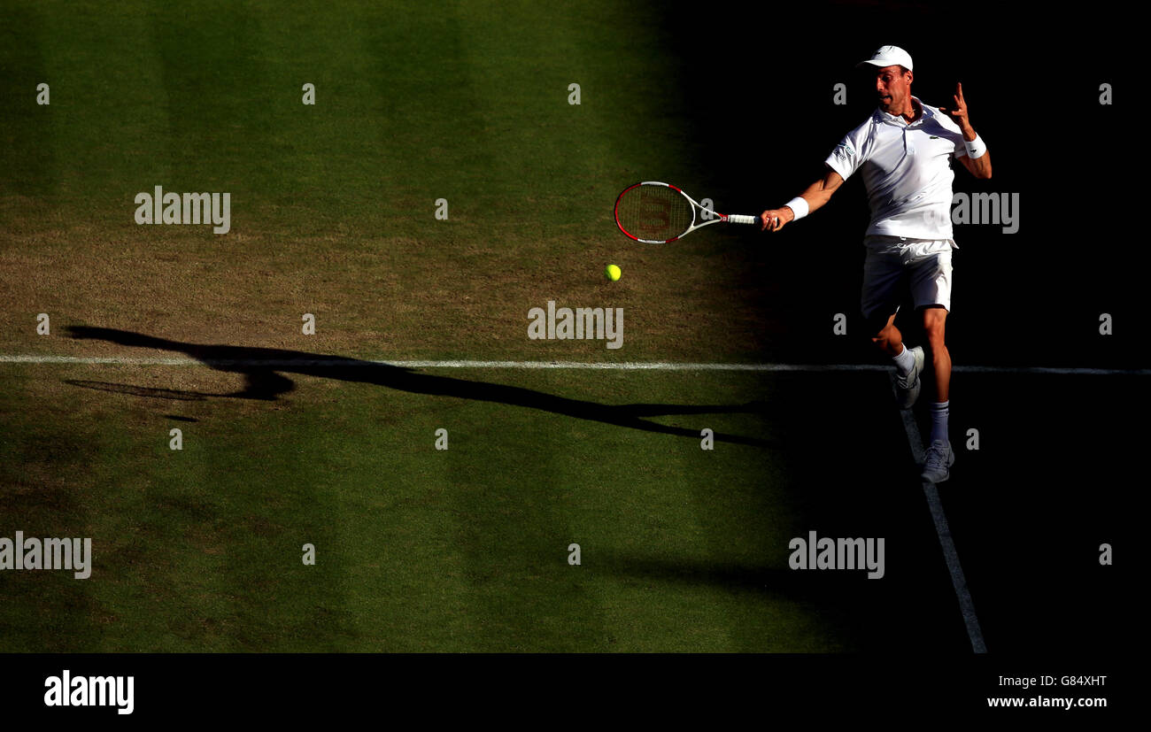 Roberto Bautista Agut in action against Roger Federer during day Seven of the Wimbledon ...